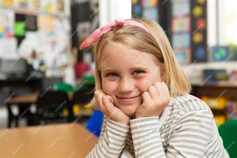 Premium Photo Schoolgirl Sitting At Desk In The Classroom At School
