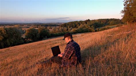 Man Using Laptop Sitting On A Hill Stock Image Image Of Network
