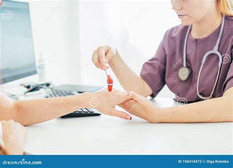 Neurological Examination The Neurologist Testing Reflexes On A Female Patient Using A Hammer