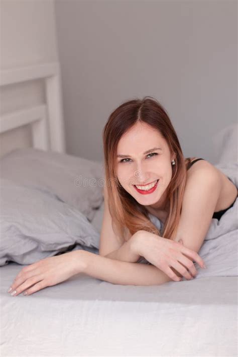 Pretty Redhead Woman In Black Lace Lingerie On Bed With Grey Sheets Stock Image Image Of Lace