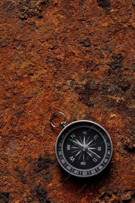Premium Photo Magnetic Compass On Rough Rusty Background