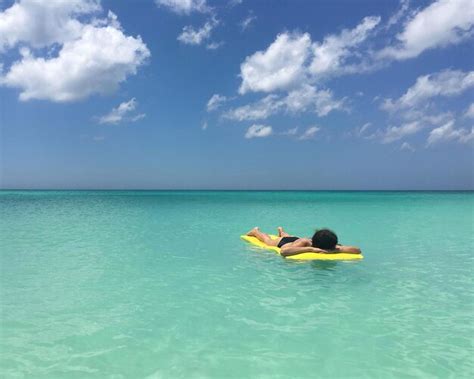 Premium Photo Woman Resting On Pool Raft In Sea Against Sky