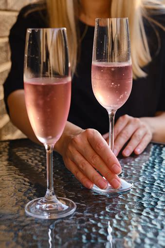 레스토랑 테라스에서 휴식을 취하는 소녀의 손에 장미 와인 한 잔 여름 휴가 축하하고 순간을 즐길 수 있습니다 알코올 음료 시음 낭만적 인 저녁 감전 와인 잔 클로즈업 고급