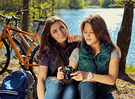 Free Photo Two Cute Brunette Girls Using Compact Photo Camera And