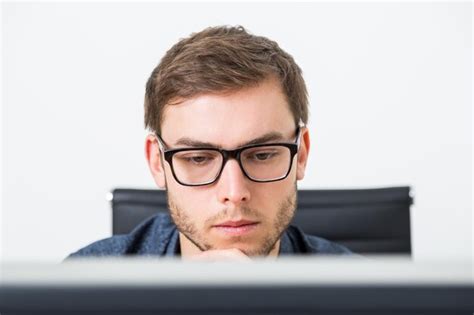Premium Photo Young Man In Glasses Analyzing Data