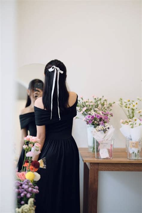 거울 검정 드레스 꽃 뒷모습 리본 서 있는 수직 쐈어 스마트폰 여성 촬영 테이블 패션 사진 흰색 배경에 관한 무료 스톡 사진