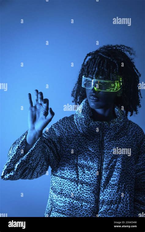 Software Engineer Wearing Futuristic Glasses Using Augmented Reality Interface Making Ok Sign On