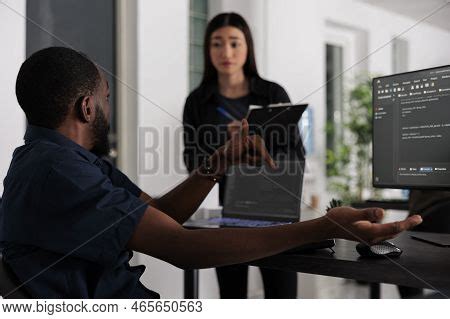 Team Of Web Developers Working At Coding Project Compiling Algorithm