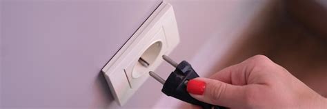 Premium Photo Closeup Of Woman Holding In Hand Inserts Plug Into Socket