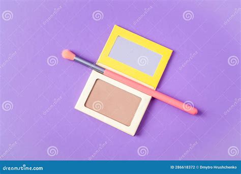 Compact Eyeshadow Palette With Makeup Brush Lie On The Purple Background Top View Makeup