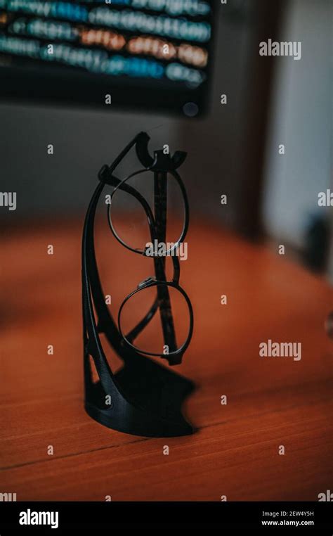 A Selective Focus Of Eyeglasses On Blurred Background Of A Computer Displaying Programming Codes