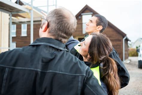 Female Carpenter Pointing While Standing By Colleagues At Site Stock Image Image Of Apprentice