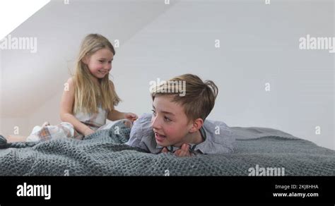Sister Tickling Her Brother On Bed Stock Video Footage Alamy