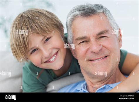 Portrait Of Grandson Hugging Grandfather Stock Photo Alamy