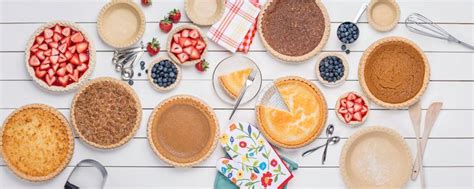 Several Pies Are Arranged On A White Table