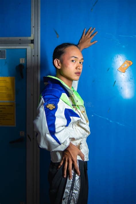 A Gay Asian Man Posing In A Tracksuit In Front Of A Blue Locker Stock Image Image Of Sweater