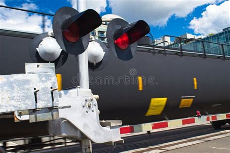 Freight Train Passing Railway Crossing With Red Signal Lights Stock