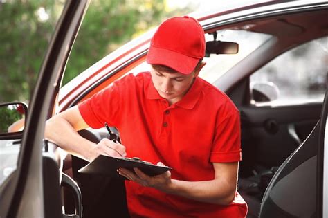 Premium Photo Pizza Delivery Boy With Tablet In Car Closeup