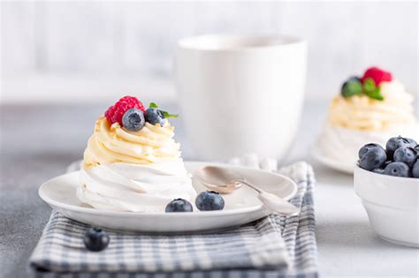 휘핑 크림과 신선한 베리를 곁들인 맛있는 파블로바 케이크 커피의 흰색 컵 선택적 초점 0명에 대한 스톡 사진 및 기타 이미지