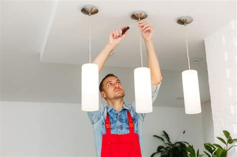 Premium Photo Electrician Man Worker Installing Ceiling Lamp