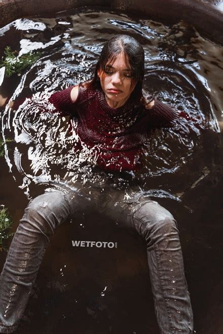 Girl Gets Wet In Sweater And Jeans And Dives Under The Water In Her
