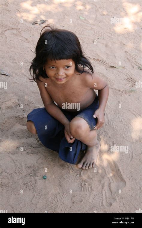 Photograph Of A Cute Cambodian Girl Playing Near A Temple In Siem Reap
