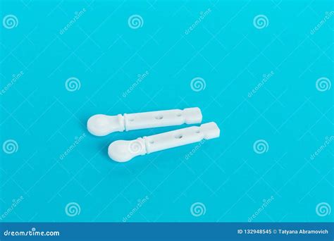 White Lancet Needle For A Glucometer Lies On A Blue Background Royalty