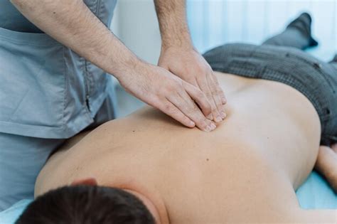 Premium Photo Therapist Performing Back Massage Therapy For Muscle