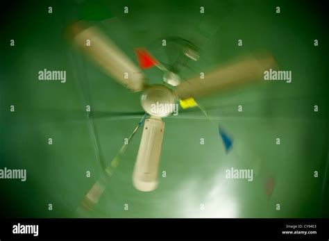 Old Ceiling Fan Spinning In A Cafe Ceiling Decorated With Colorful