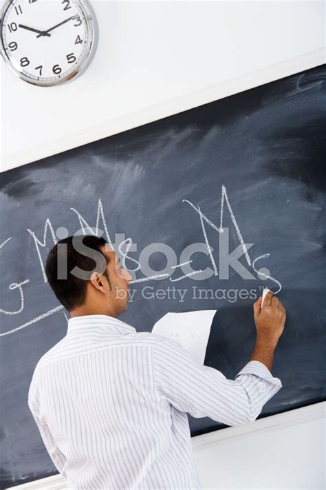 Male Teacher Or Student Writing On Chalkboard In Classroom Stock Photo Royalty Free FreeImages