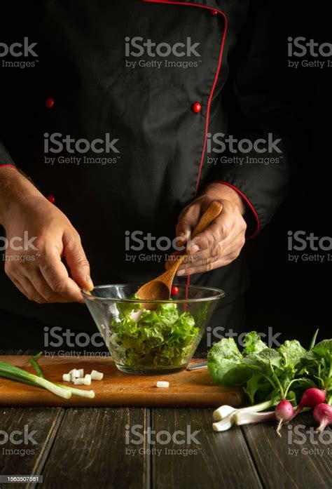 요리사는 양상추 잎을 그릇에 숟가락으로 섞습니다 식당 식탁에서 일하는 환경 요리사의 손에 의해 신선한 야채와 함께 맛있는 샐러드 개체 그룹에 대한 스톡 사진 및 기타 이미지
