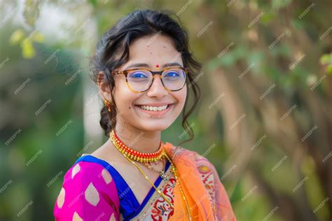 A Cheerful Indian Woman Wearing Glasses And A Vibrant Sari An Indian Woman With A Cheerful Smile