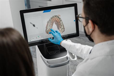 Male Doctor Show Results Of Digital Intraoral Scan Of Patient Teeth In 3d On Display Stock