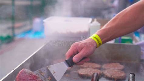 Closeup Of Burger Patties Getting Cooked On A Hot Grill Stove In A