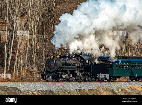 View Of A Narrow Gauge Restored Steam Passenger Train Blowing Smoke And