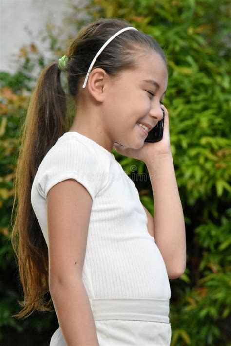 Philippina Female With Long Hair Wearing Hair Band Using Mobile Phone