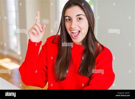 Beautiful Young Woman Wearing Casual Red Sweater Pointing Finger Up With Successful Idea Exited