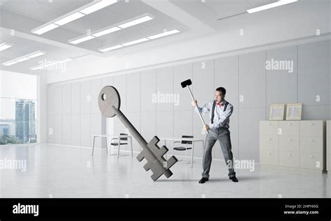 breaking through access concept with man in crashing concrete key stock