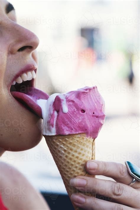 Image Of Close Up Of Girl Licking An Ice Cream Cone Austockphoto
