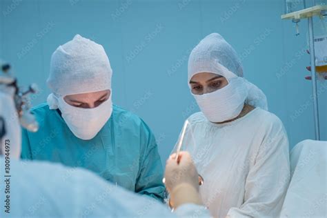 Operational Team Girl Surgeon Looking At The Camera During An Operation Conditions For A