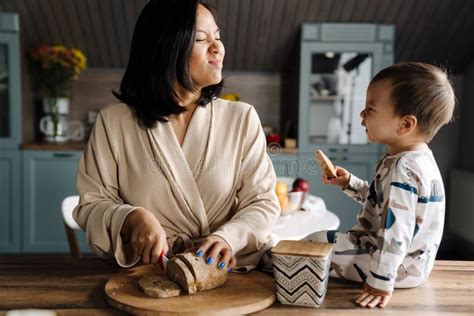 Happy Mother Making Fun With Her Son While Cutting Bread Stock Image Image Of Brunette Mother