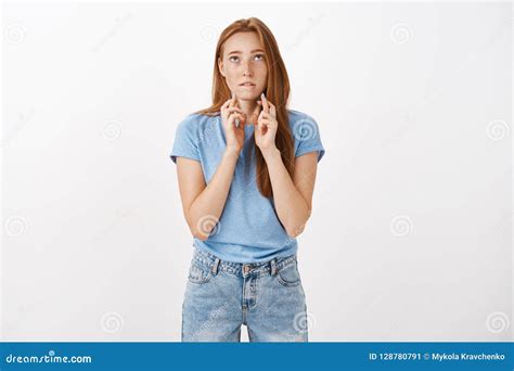 Cute Redhead Woman Hopes God Hears Prayers Biting Lower Lip While Standing Intense Over Gray