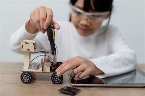Premium Photo Asia Students Learn At Home In Coding Robot Cars And