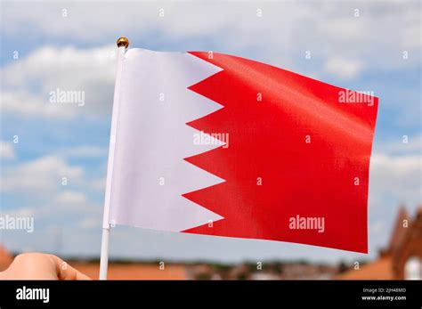 Close Up Of National Flag Of Bahrain On Blue Sky Background Red And