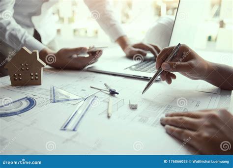 Engineers Are Helping To Design Work On Blueprints And Collaborate On Structural Analyzing Of