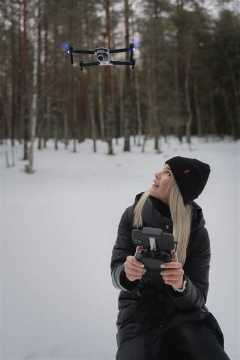 Girl Piloting A Drone In Nature In Winter Vertical Photo Stock Image Image Of Fores Trees