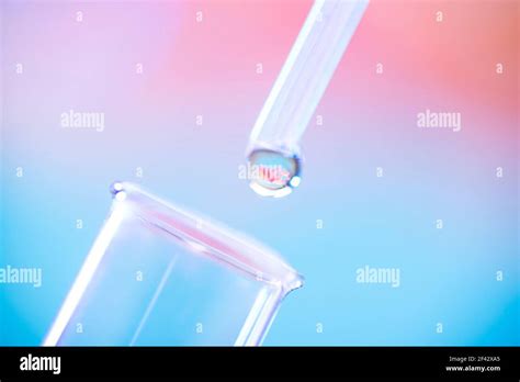 Chemical Test Tube And Pipette With A Drop Of Colorless Liquid Close Up On Blue Background Stock