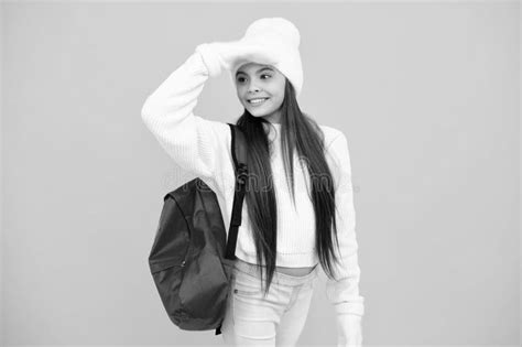 Back To School Teenager Schoolgirl With Warm Hat And Sweater On Yellow