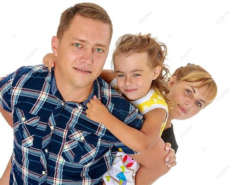 Dad Stands In Front As Mom And Daughter Peek From Behind Photo