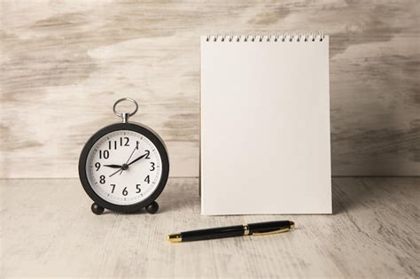 Premium Photo Alarm Clock And Notebook On The Table